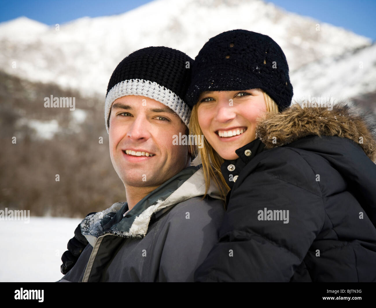 Couple on snow mobile Stock Photo - Alamy