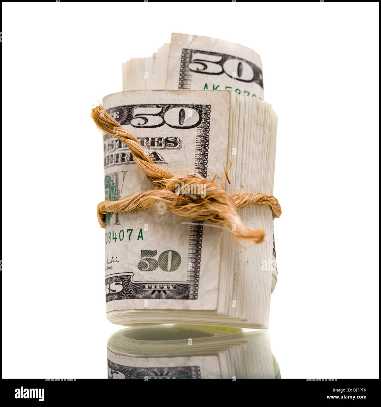 Roll of US bank notes tied with twine Stock Photo - Alamy