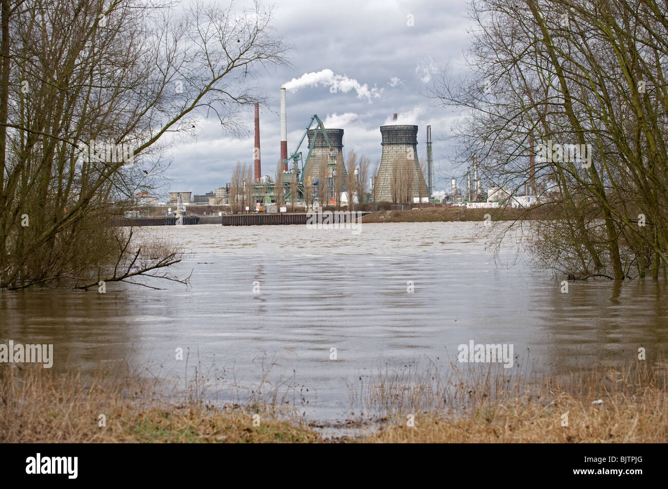 Flooded river and oil refinery, Germany Stock Photo - Alamy