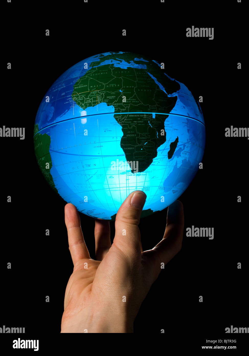 Hand holding earth globe on fingertips Stock Photo - Alamy