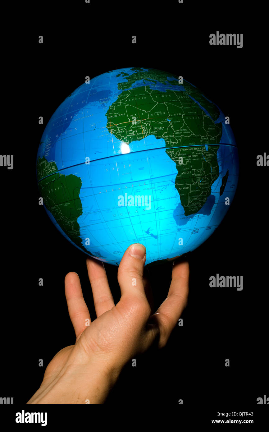 Hand holding earth globe on fingertips Stock Photo - Alamy
