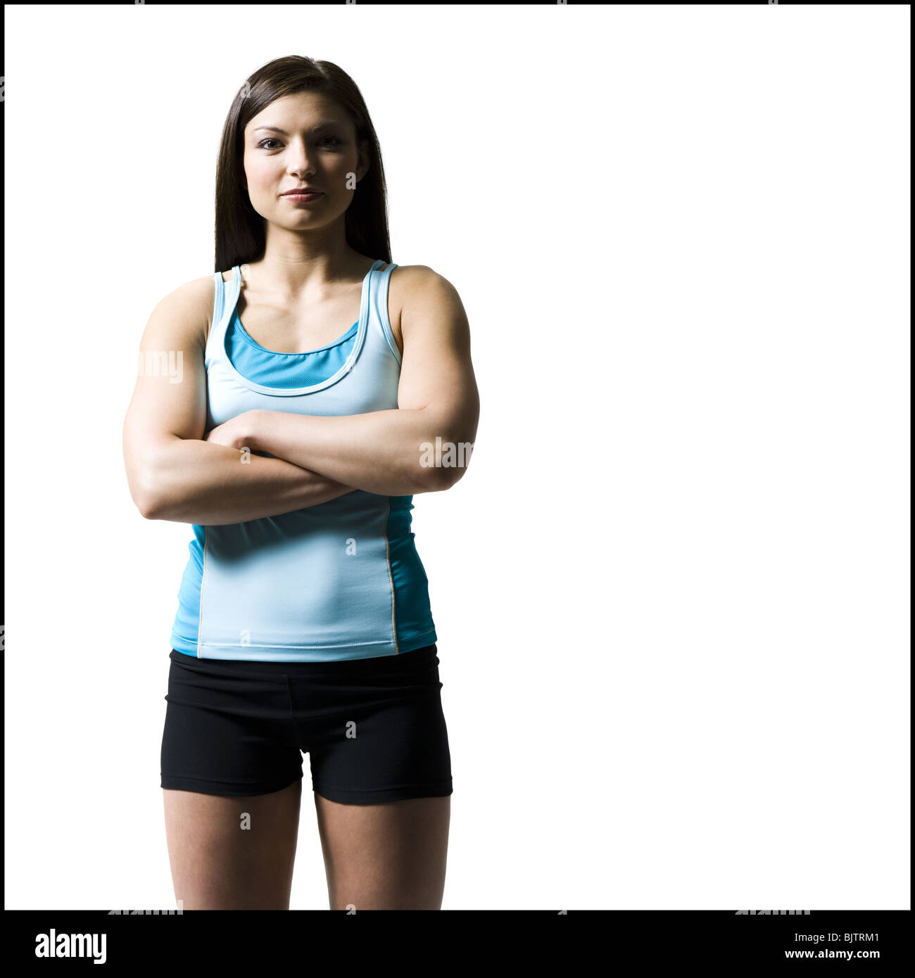 Woman standing with arms crossed Stock Photo - Alamy