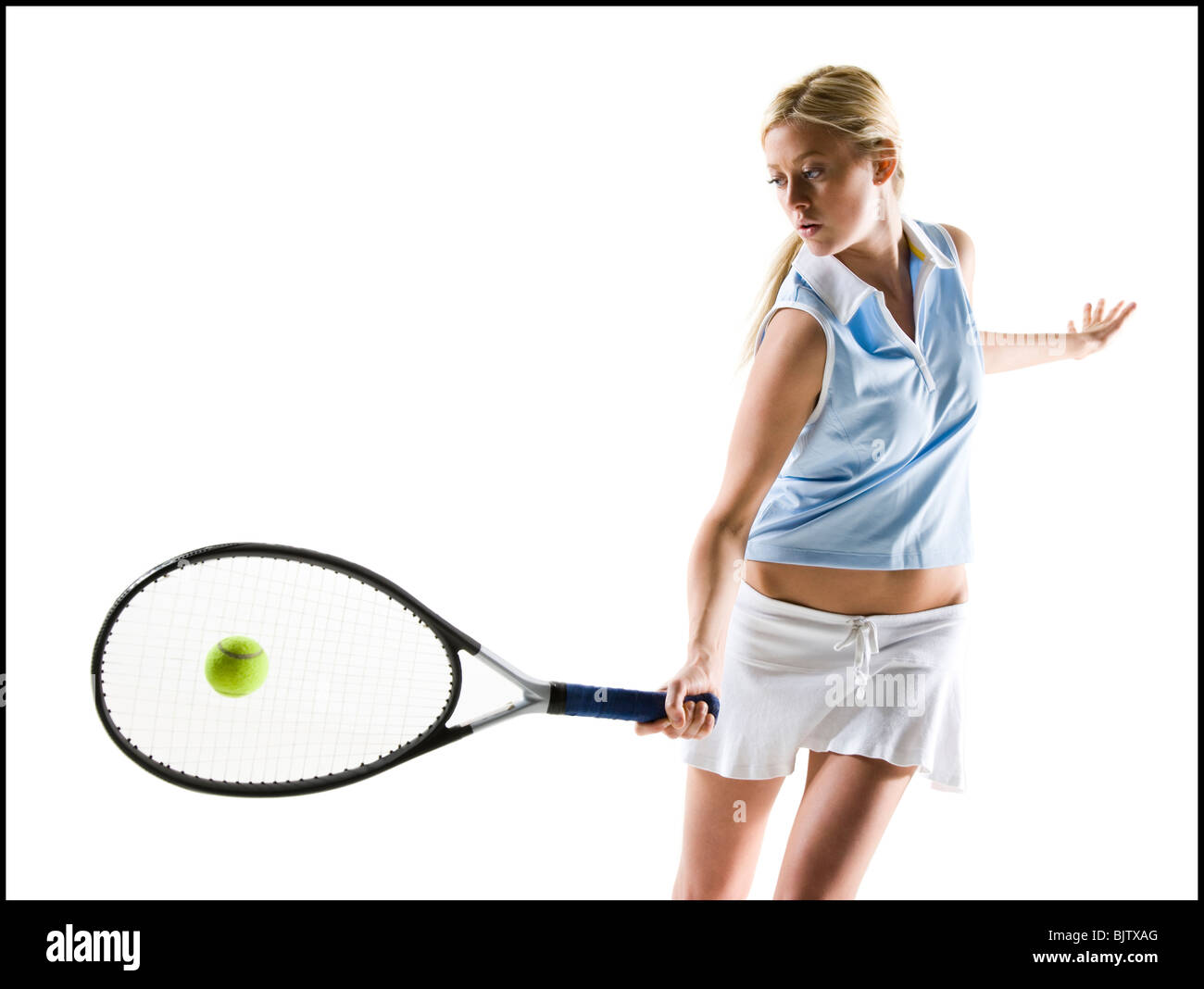 Tennis player hitting ball Stock Photo - Alamy