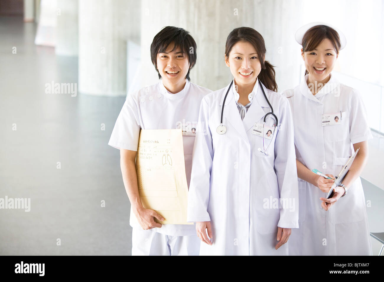 Doctor nurse and an x-ray technician smiling at the camera Stock Photo ...