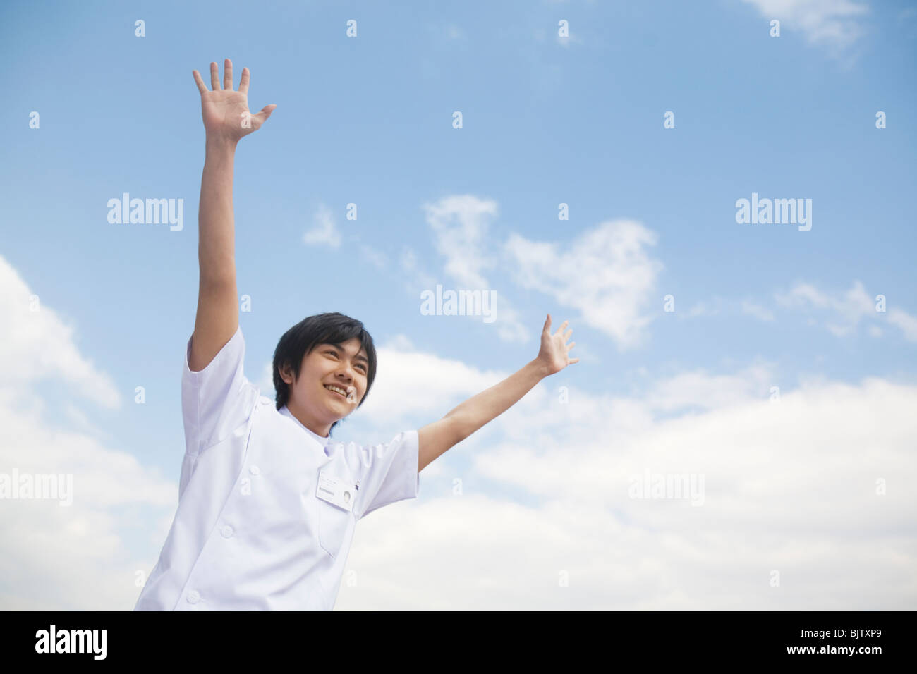 Nurse outside with raised arms Stock Photo - Alamy