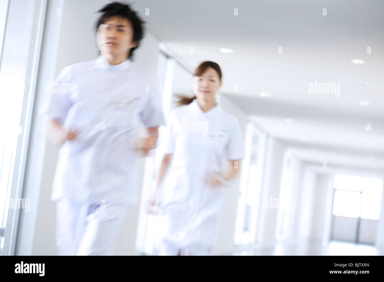 Doctor and nurse running through hospital Stock Photo - Alamy