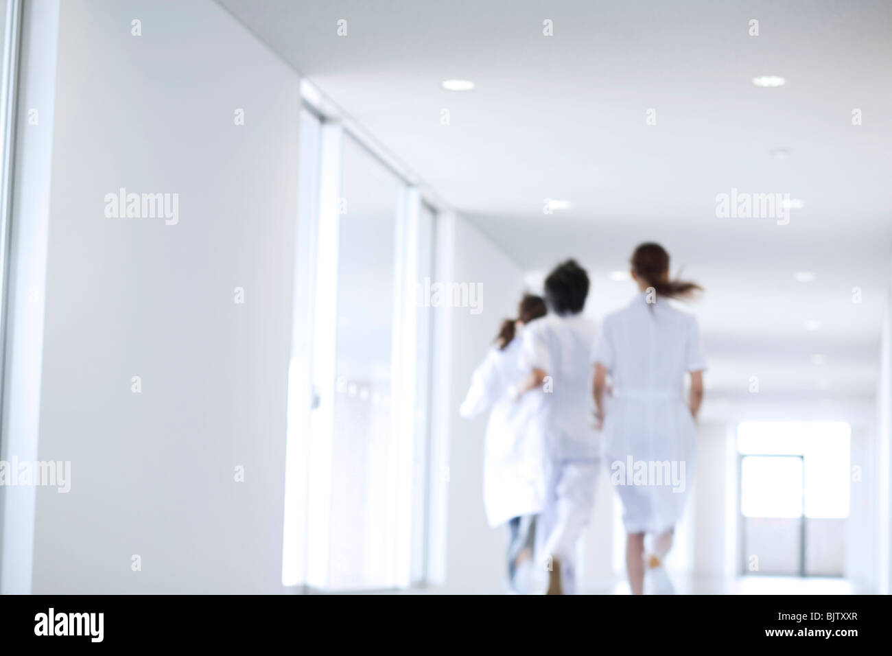 Doctor and nurses running through hospital Stock Photo - Alamy