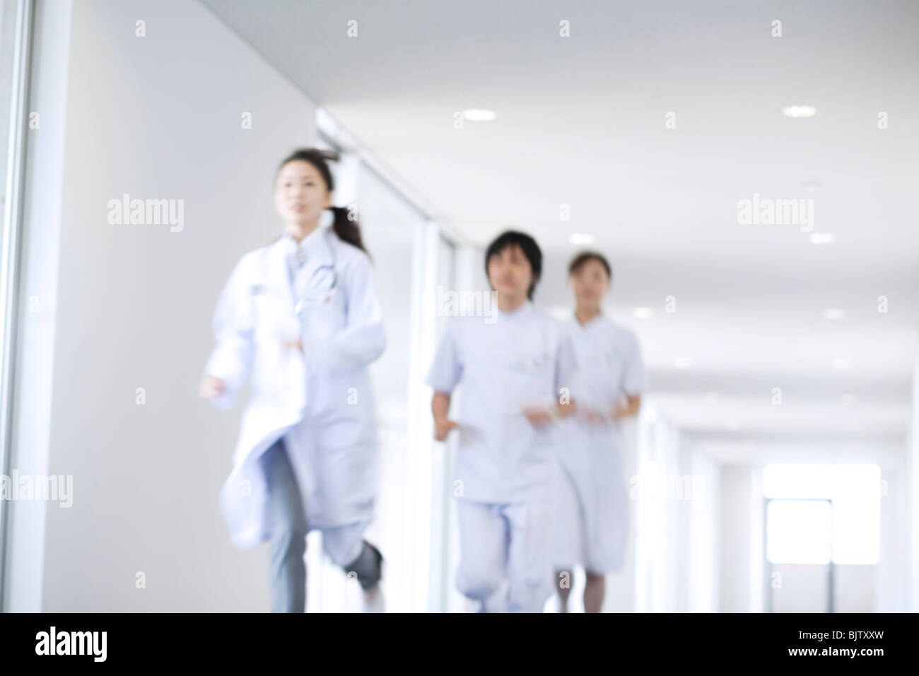 Doctor and nurses running through hospital Stock Photo - Alamy