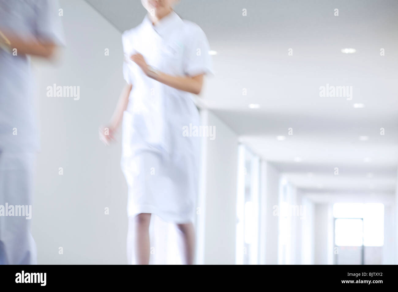 Doctor and nurse running through hospital Stock Photo - Alamy