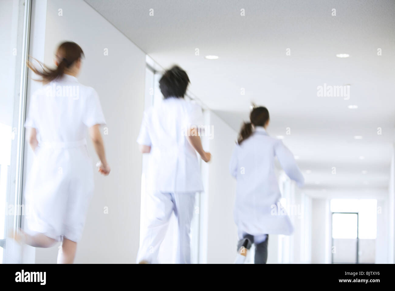 Doctor and nurses running through hospital Stock Photo - Alamy