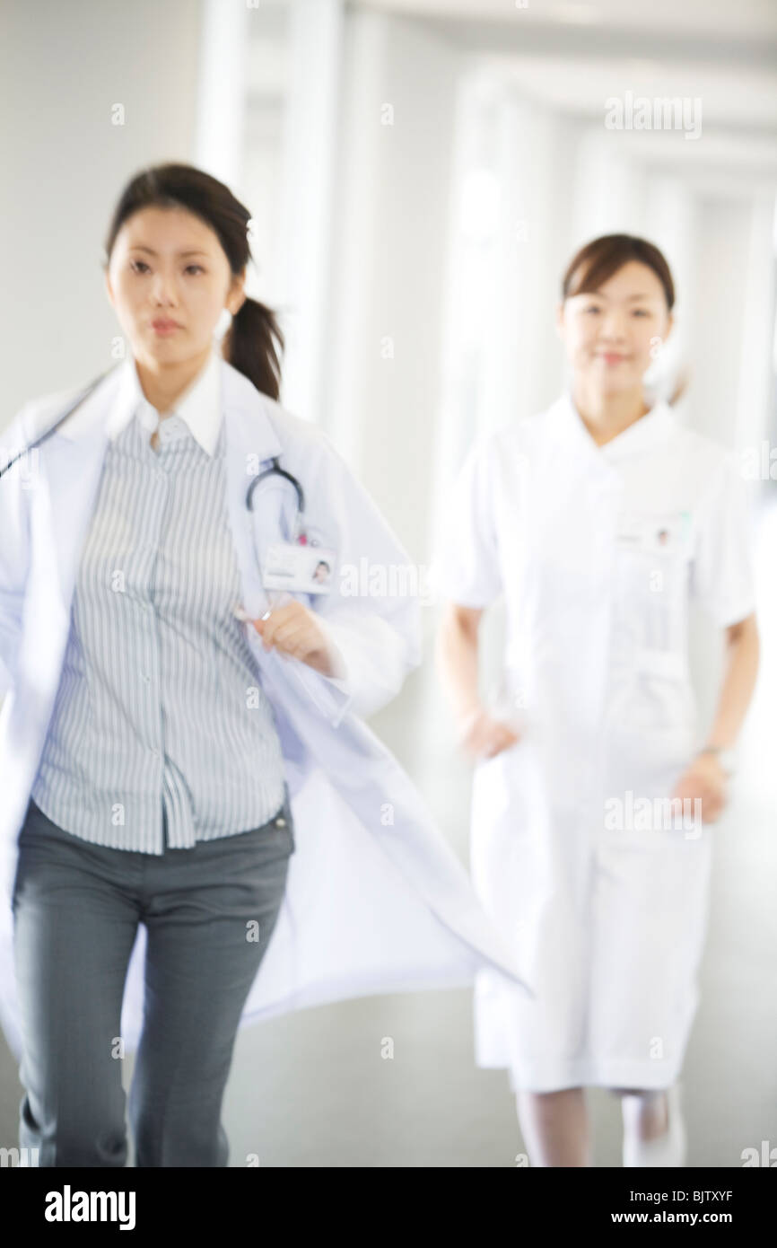 Doctor and nurse running through hospital Stock Photo - Alamy