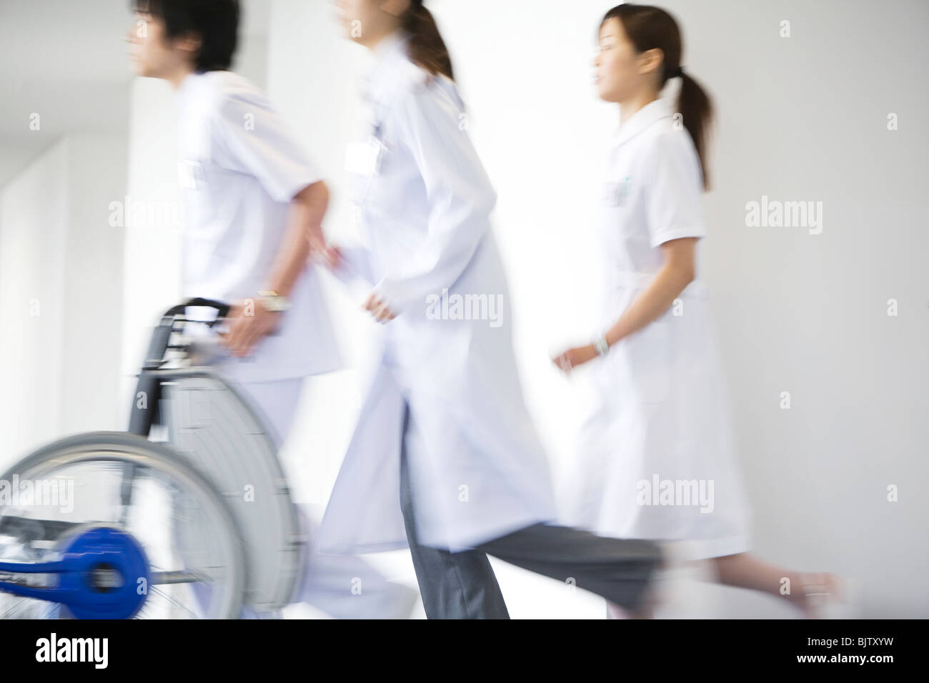 Doctor and nurses running through hospital Stock Photo - Alamy