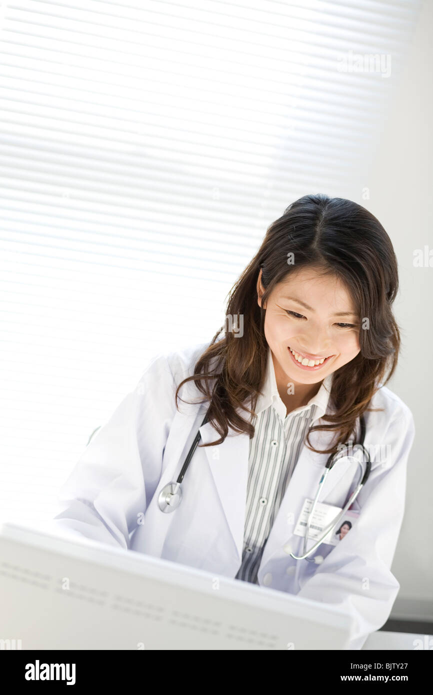 Female doctor using a computer Stock Photo - Alamy
