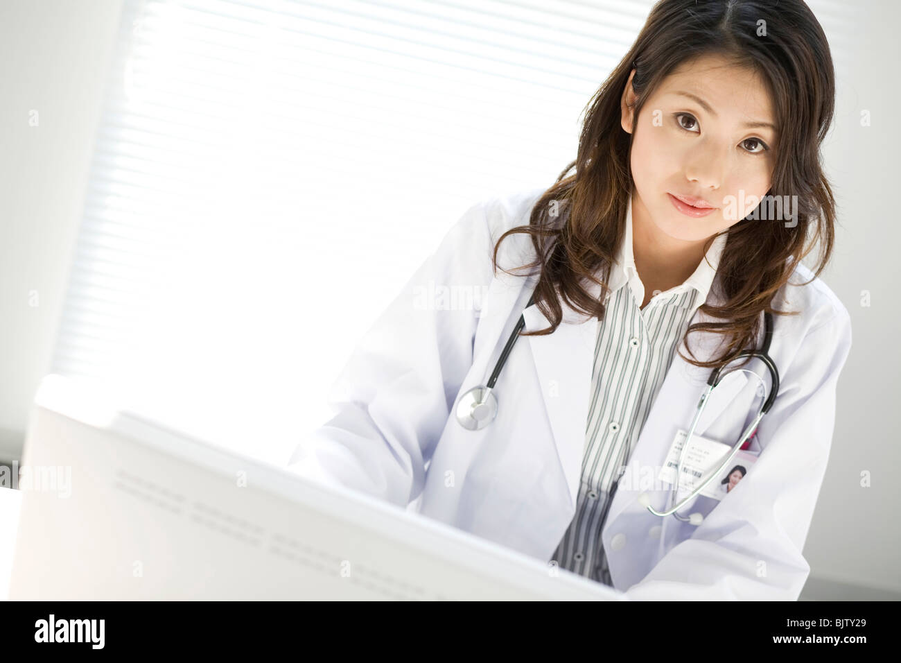Female doctor using a computer Stock Photo - Alamy