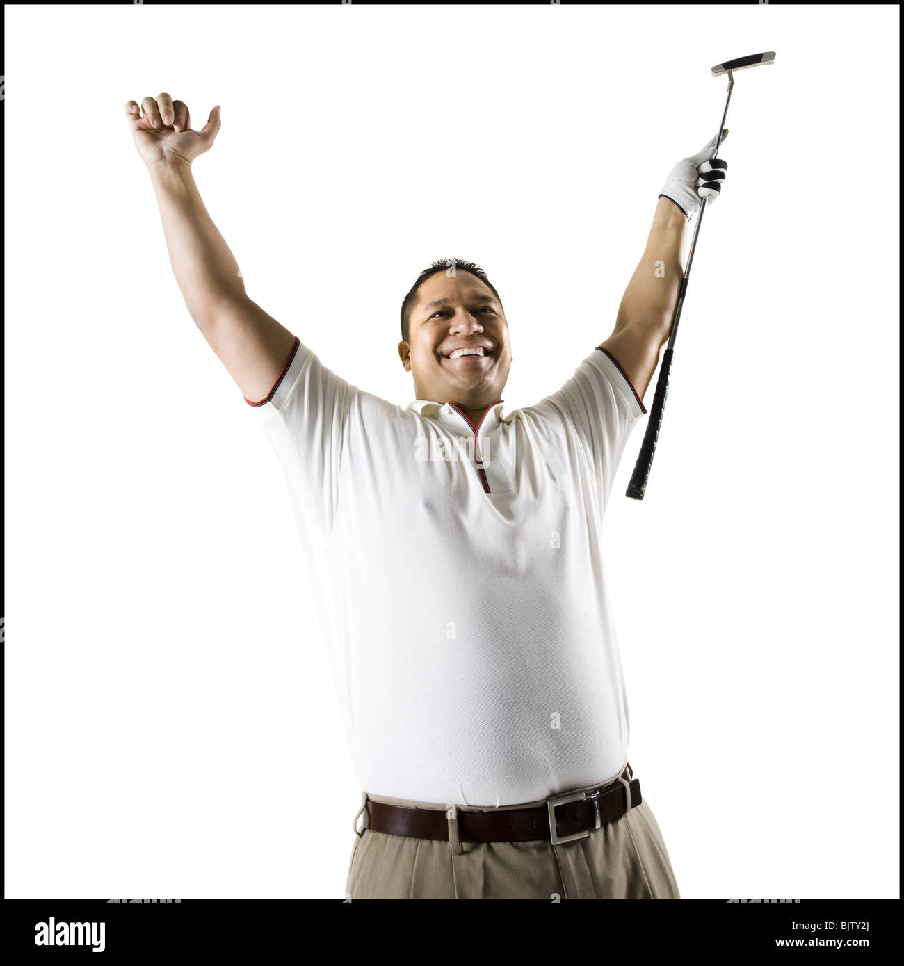Golfer raising arm and club Stock Photo - Alamy