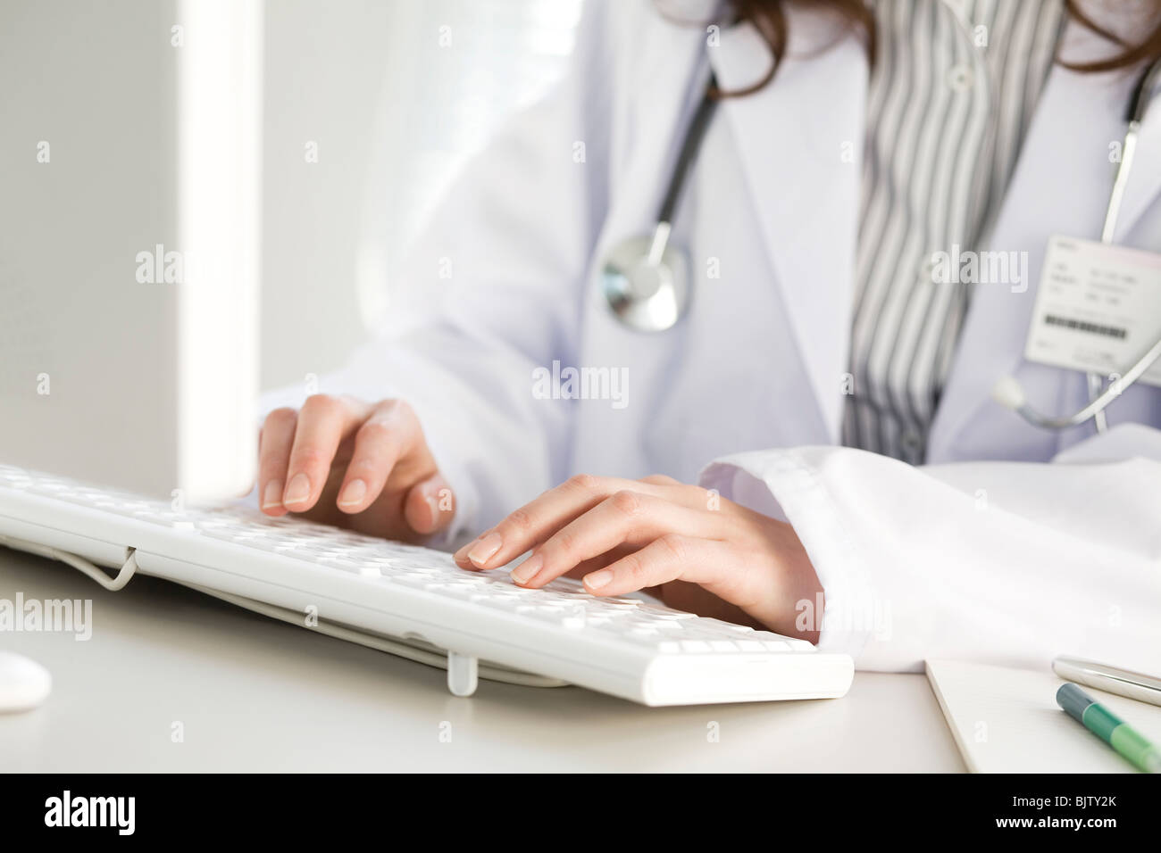 Female doctor using a computer Stock Photo - Alamy