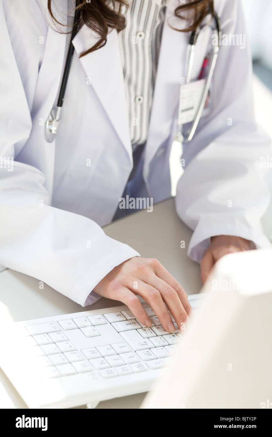Female doctor using a computer Stock Photo - Alamy