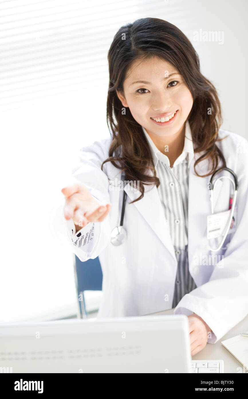 Female doctor holding out her hand Stock Photo - Alamy