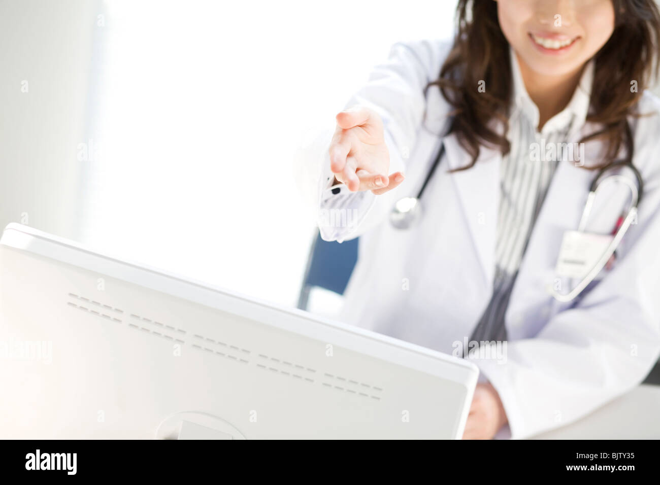 Female doctor holding out her hand Stock Photo - Alamy