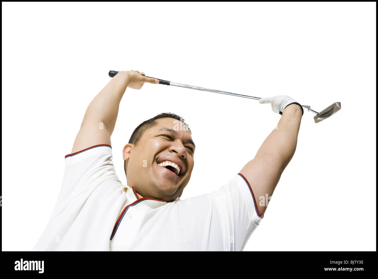 Golfer raising arm and club Stock Photo - Alamy