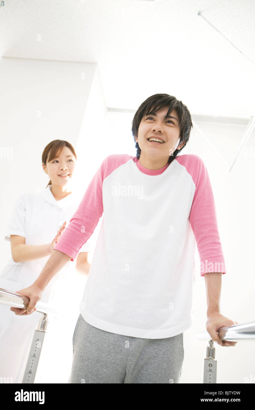 Nurse assisting a patient with rehabilitation Stock Photo - Alamy