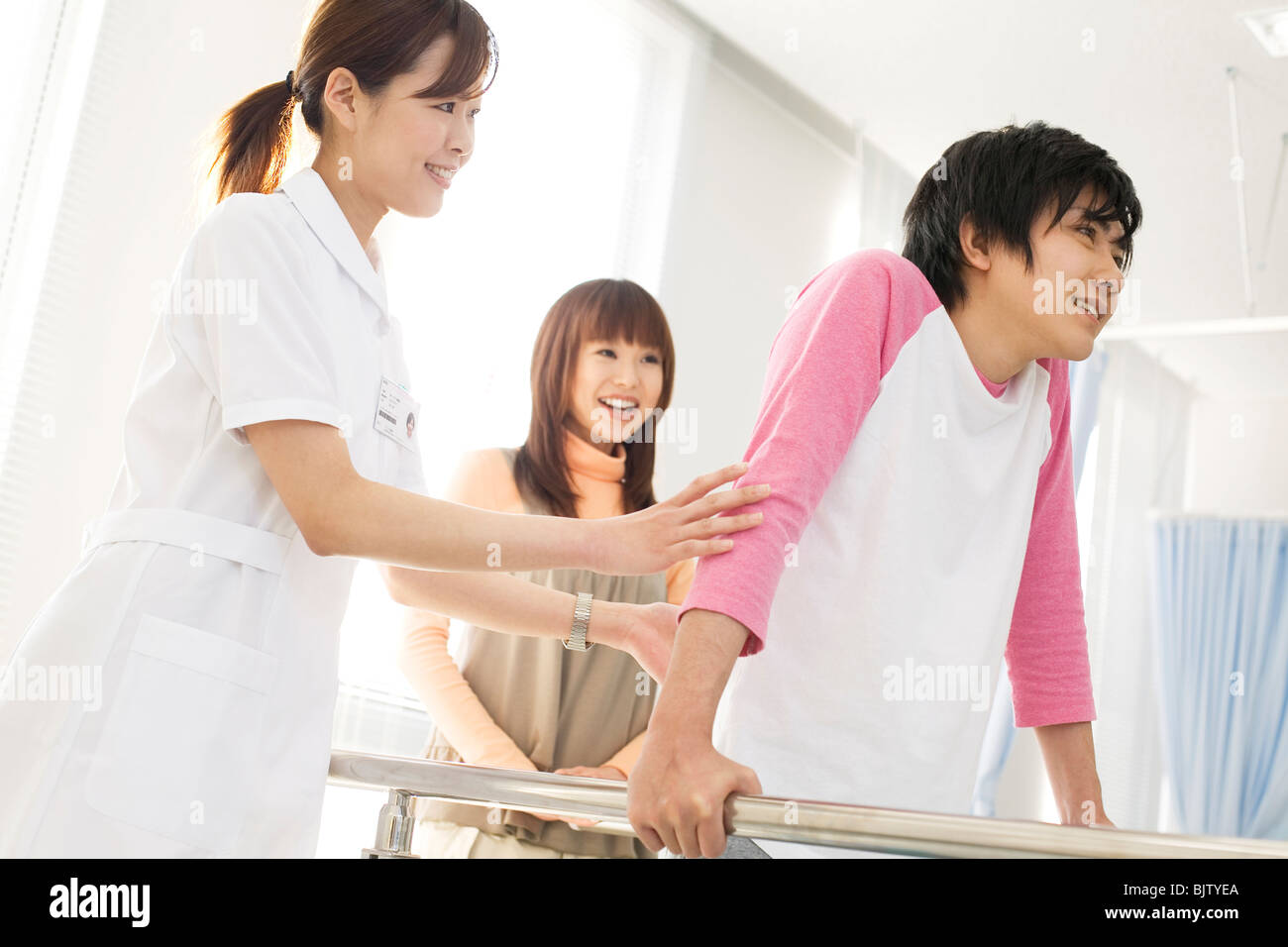 Woman encouraging her boyfriend with his rehabilitation Stock Photo - Alamy