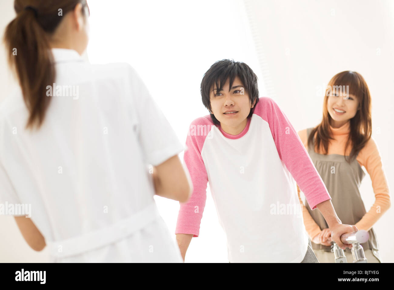 Woman encouraging her boyfriend with his rehabilitation Stock Photo - Alamy