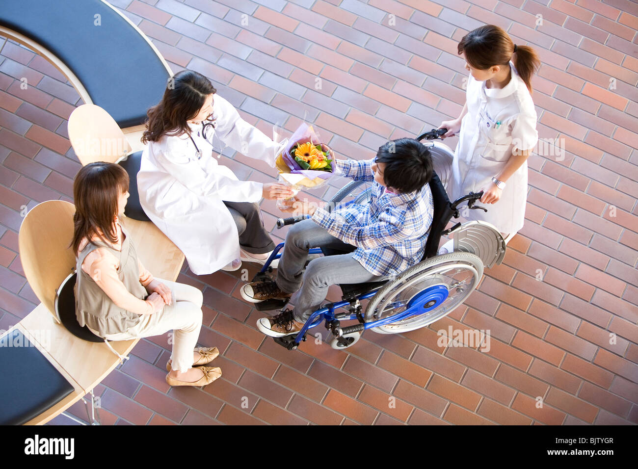 Doctor giving patient a bunch of flowers as he leaves hospital Stock ...