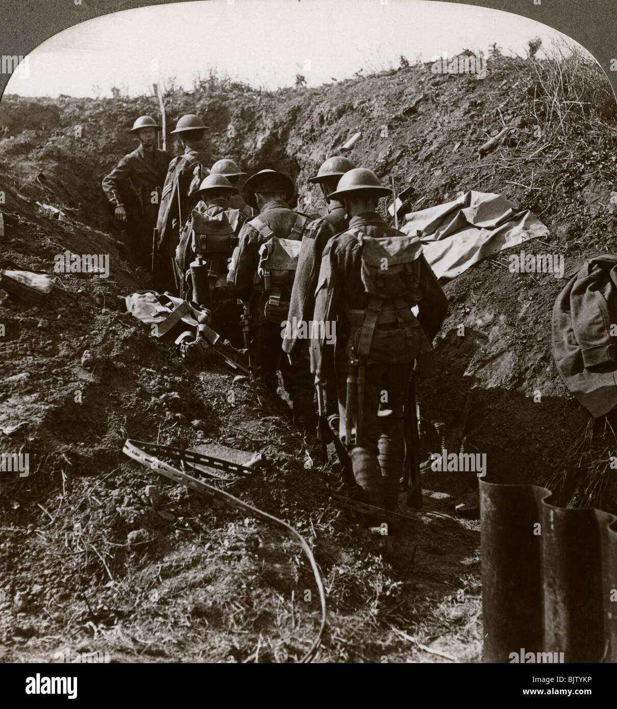 Officer watching his men file into a dug-out to avoid a German strafe ...