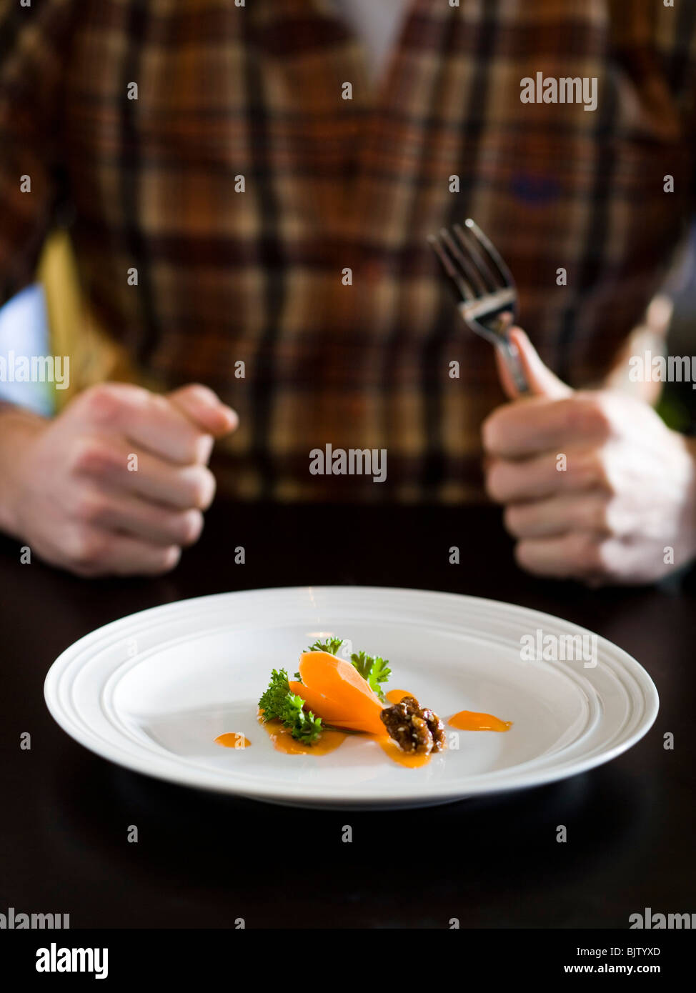 Person with small amount of food Stock Photo - Alamy