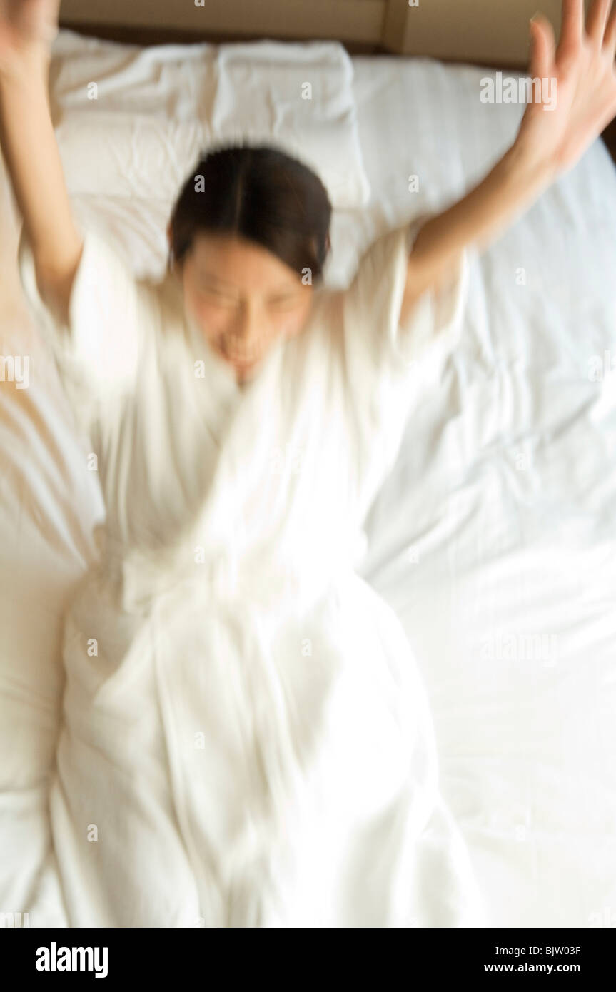 Woman jumping onto bed hi-res stock photography and images - Alamy