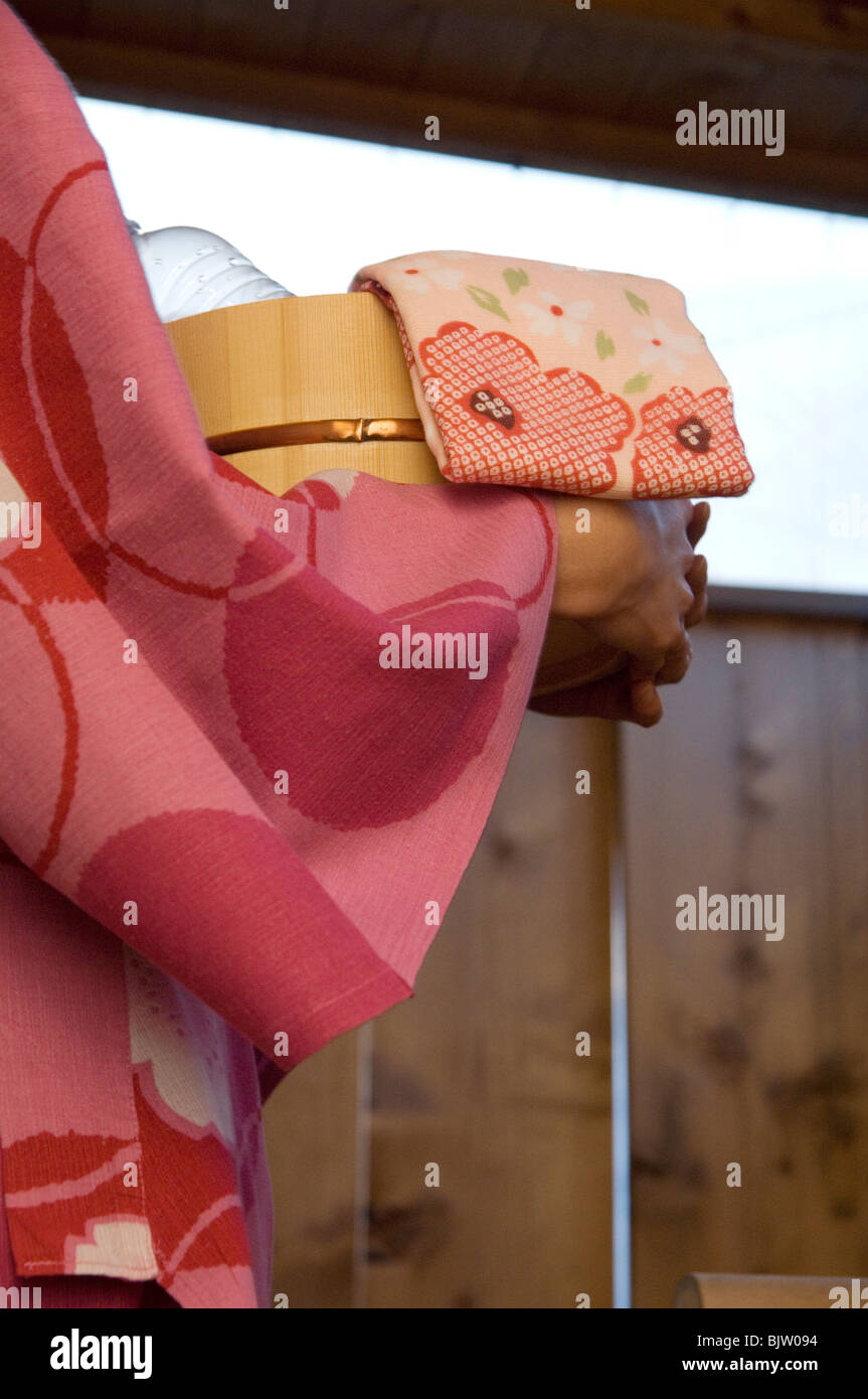 Women wearing yukata holding spa products at a health spa Stock Photo ...