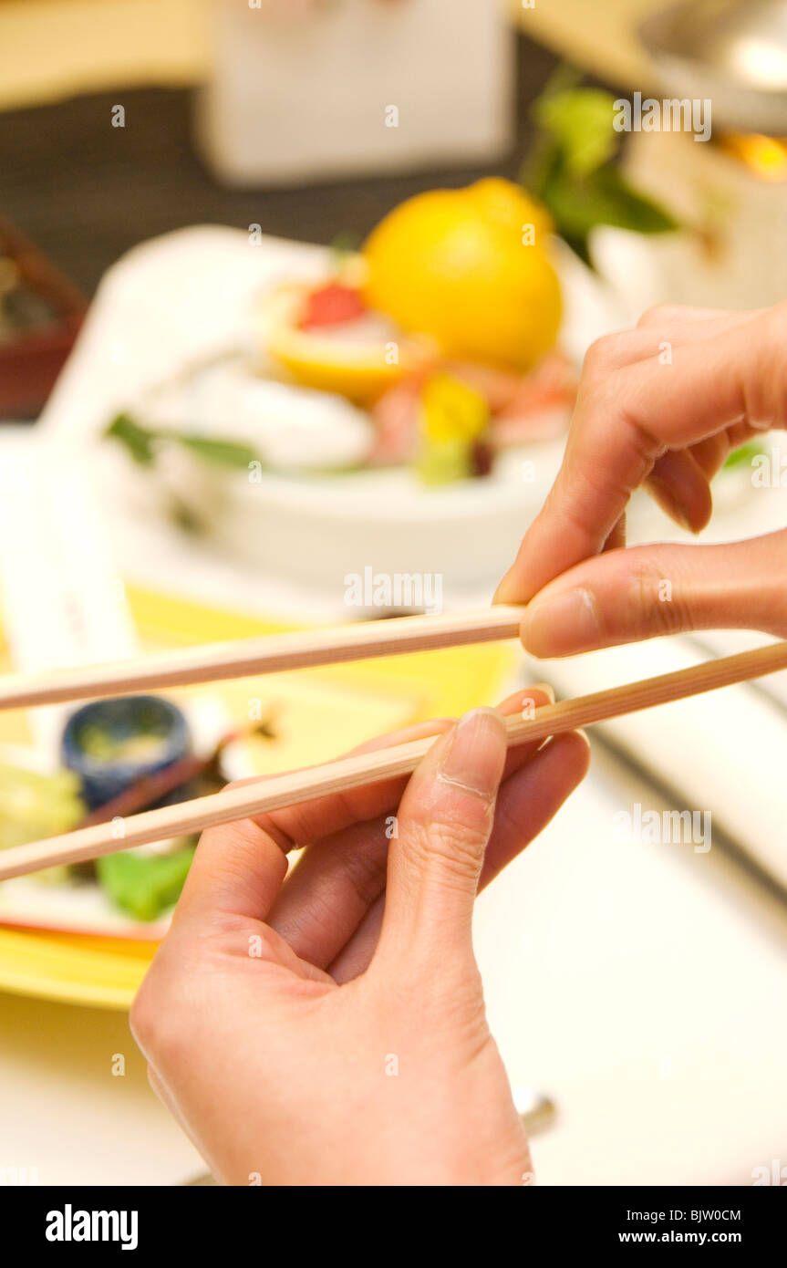 Woman splitting chopsticks Stock Photo - Alamy