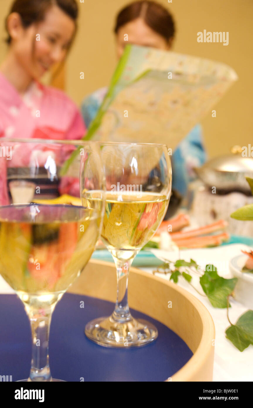 Women sitting at table with meal reading map Stock Photo - Alamy