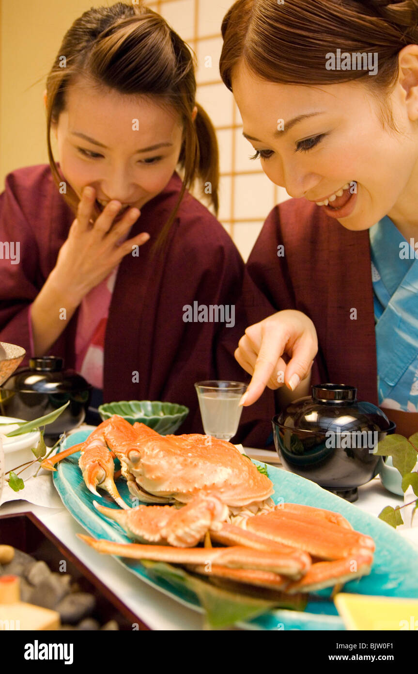 Women pointing and laughing at cooked crab on plate Stock Photo - Alamy