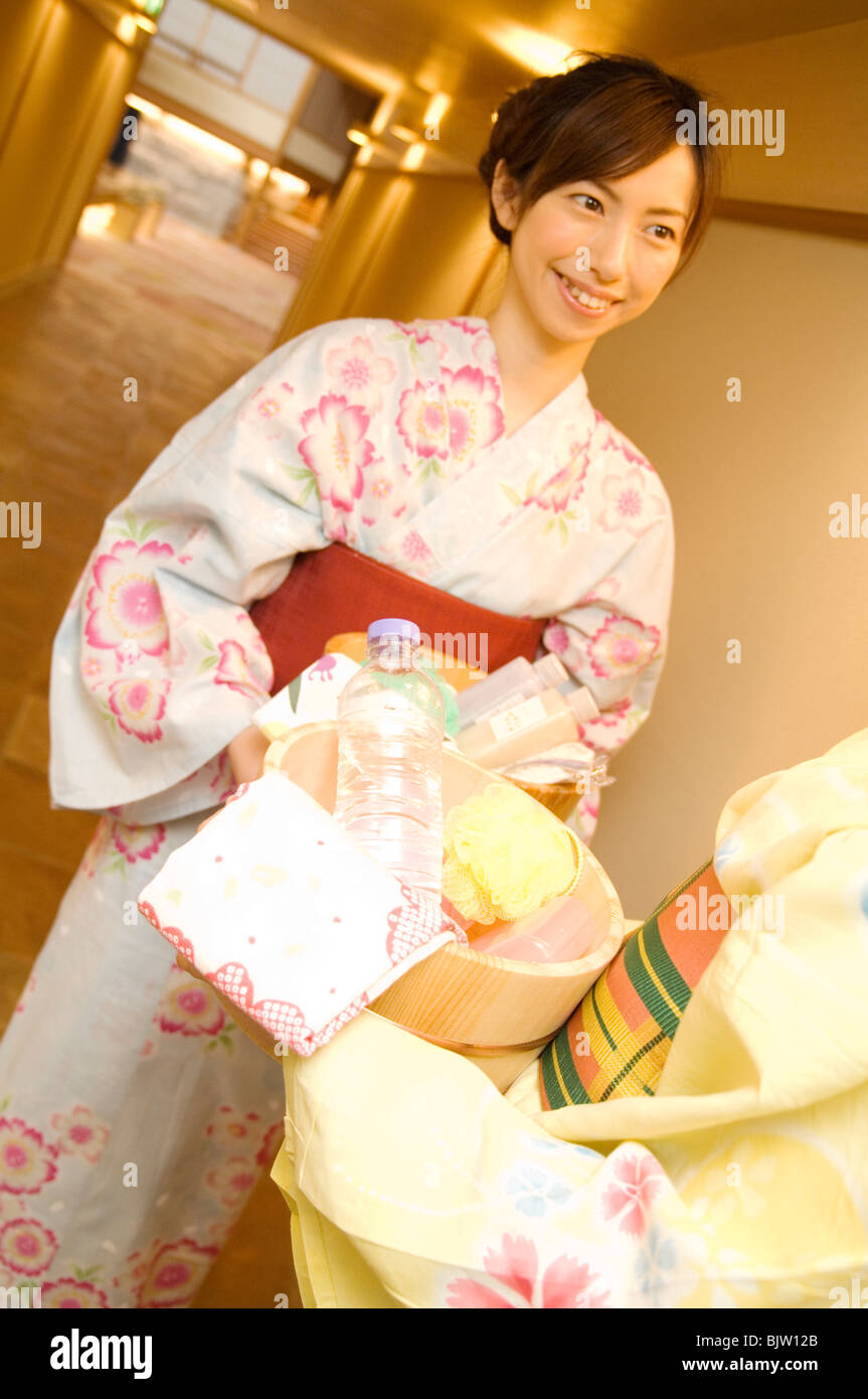 Women wearing yukata standing talking in hallway of health spa Stock ...