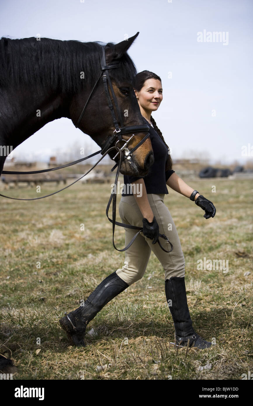 Woman walking with horse Stock Photo - Alamy