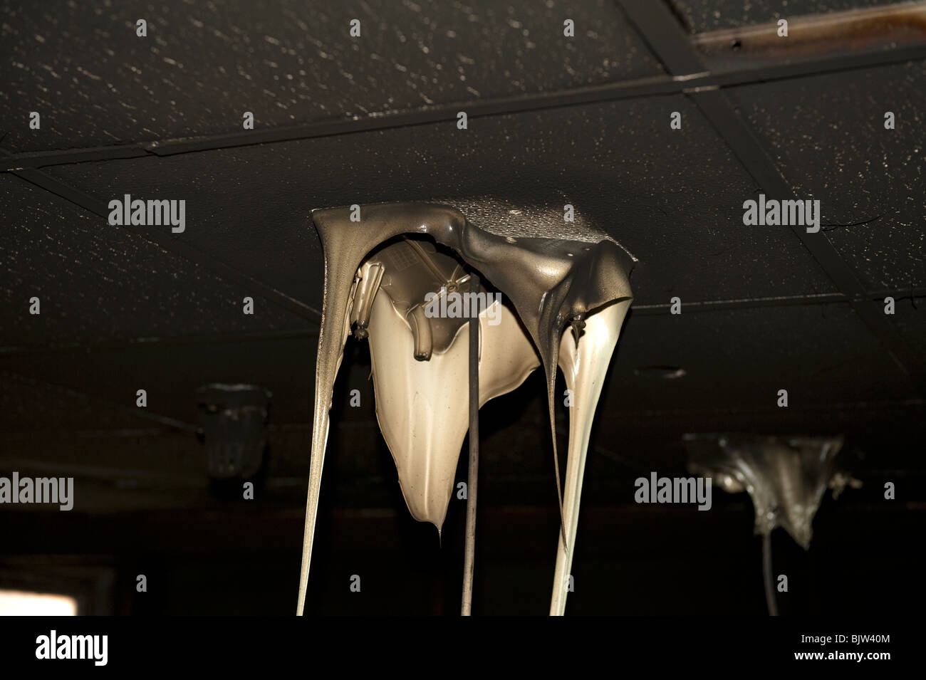 Melted plastic ceiling light following office fire Stock Photo - Alamy