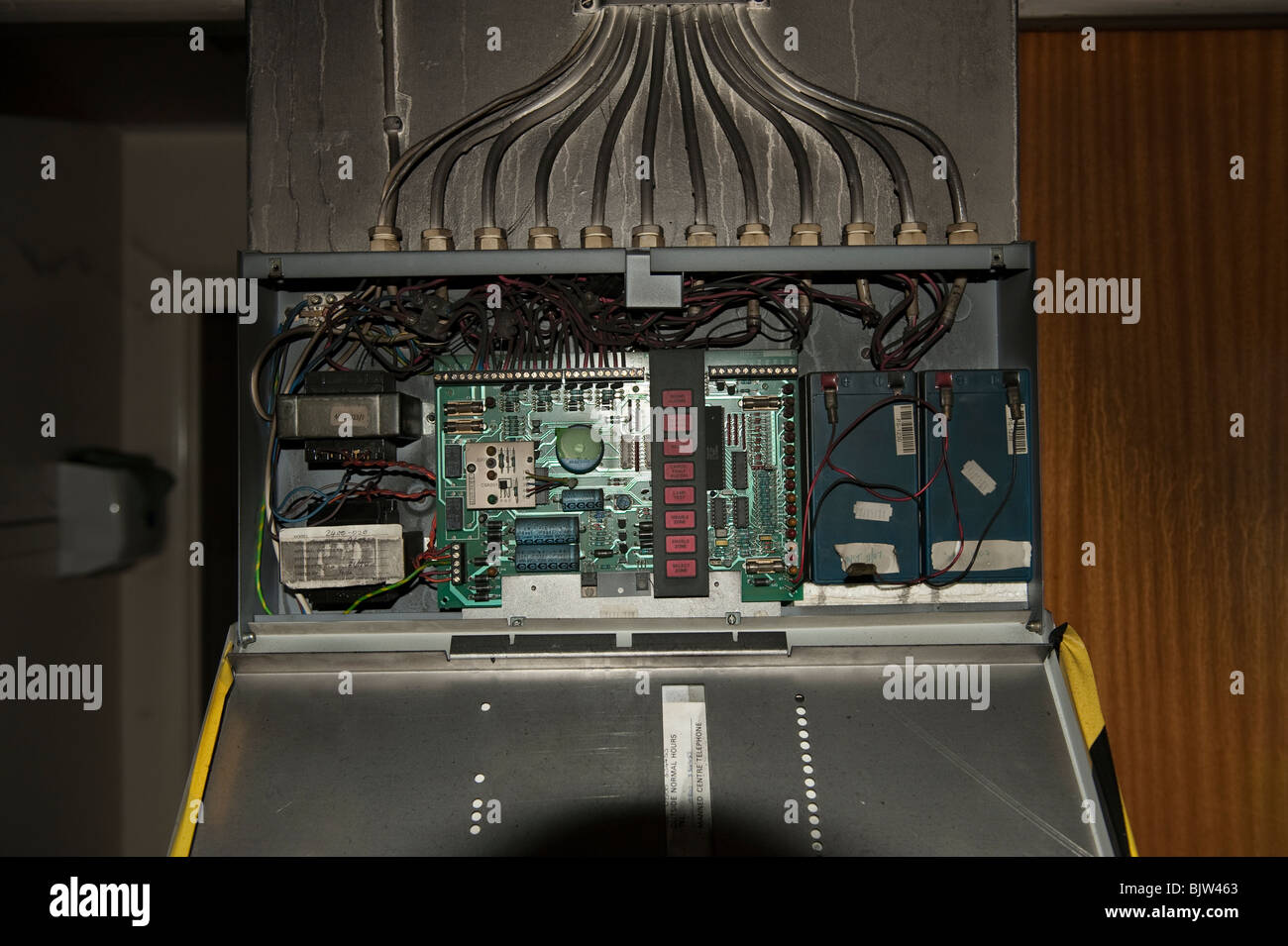 Fire alarm panel burnt and melted following fire Stock Photo - Alamy