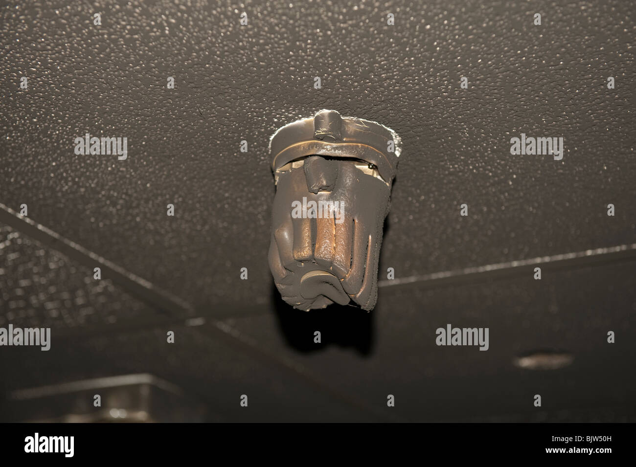 Burnt and melted smoke detector head after fire Stock Photo - Alamy