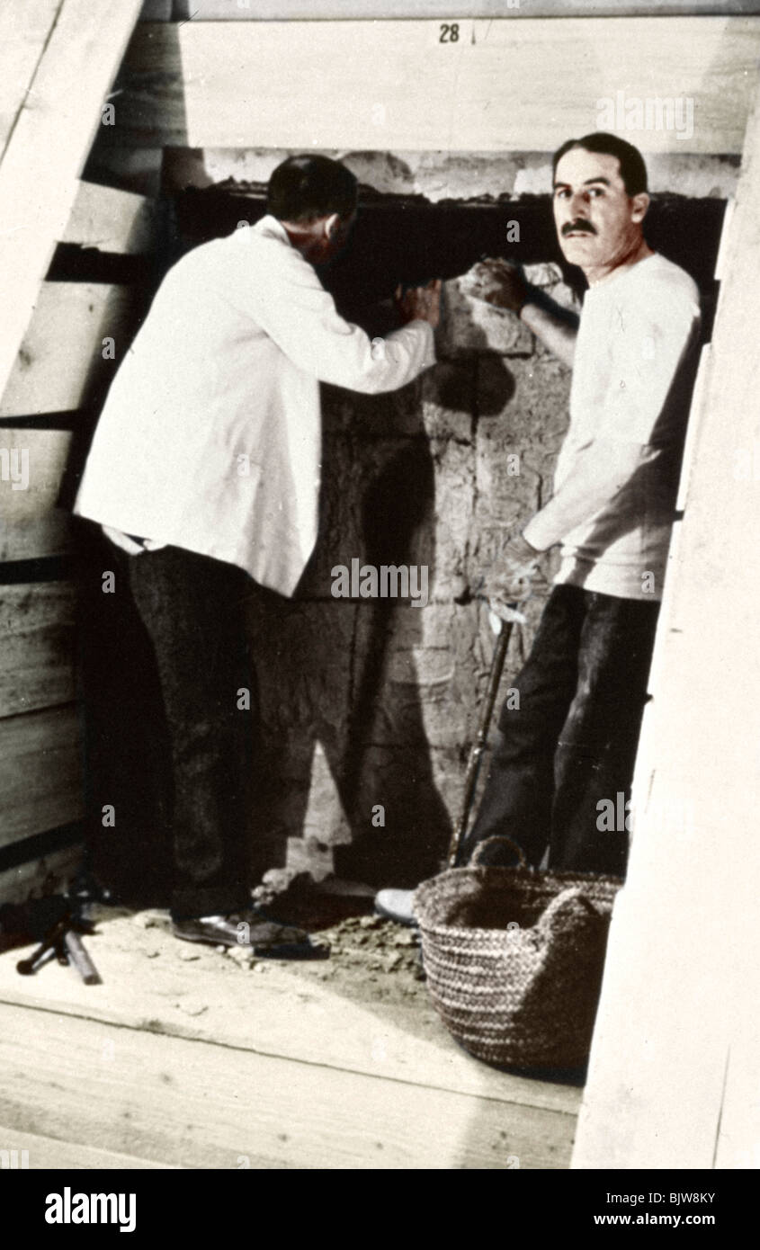 Howard Carter and a colleague excavating a tomb in the Valley of the ...