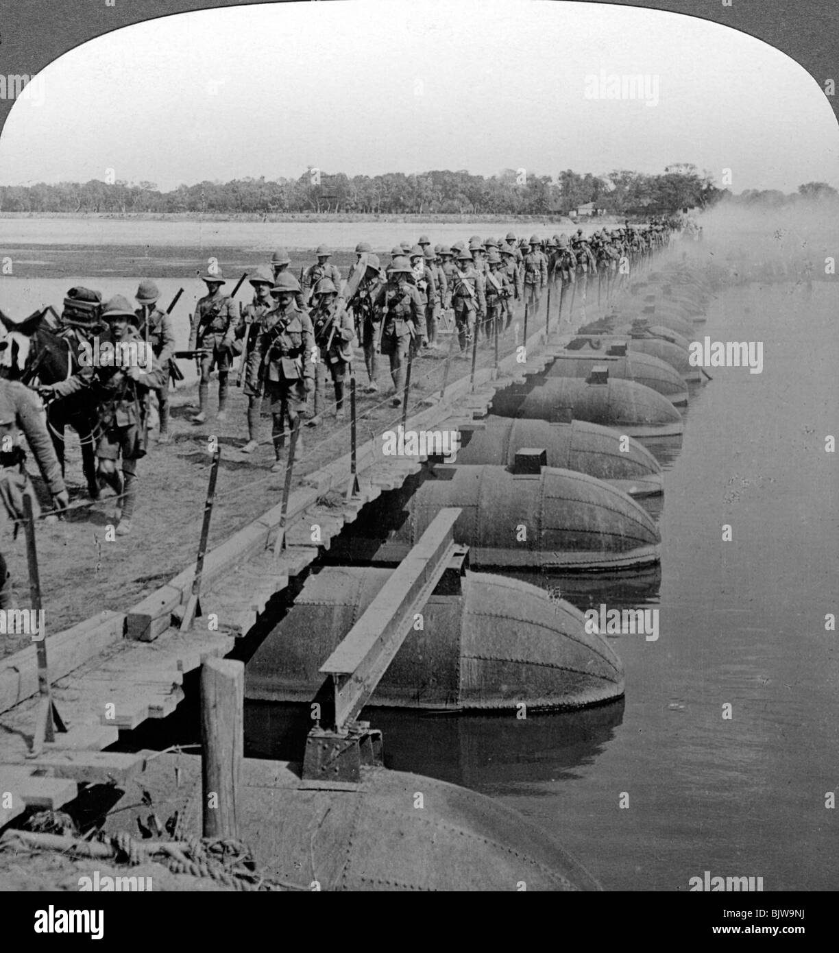 Machine gun section and infantry crossing a pontoon bridge, World War I ...