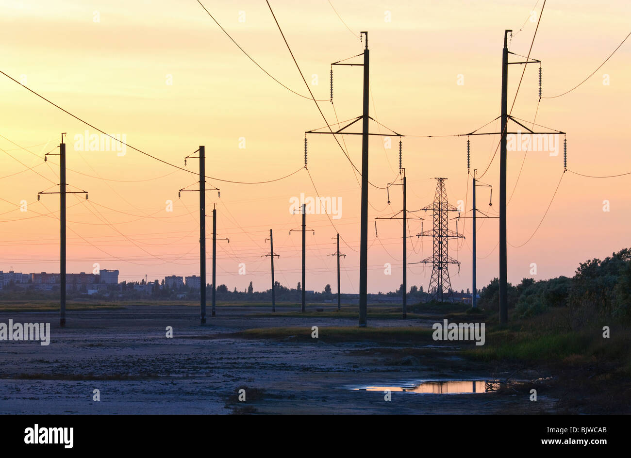 Sunset sky above the town and high-tension transmission line Stock ...