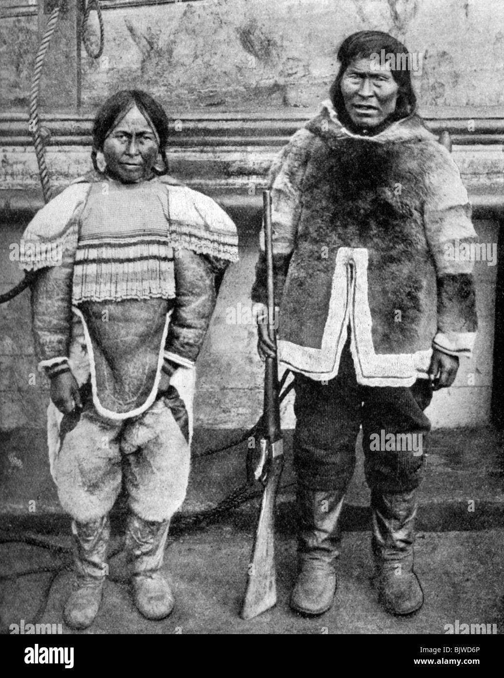 Eskimo hunter and his wife in winter costume, c1922 Stock Photo ...
