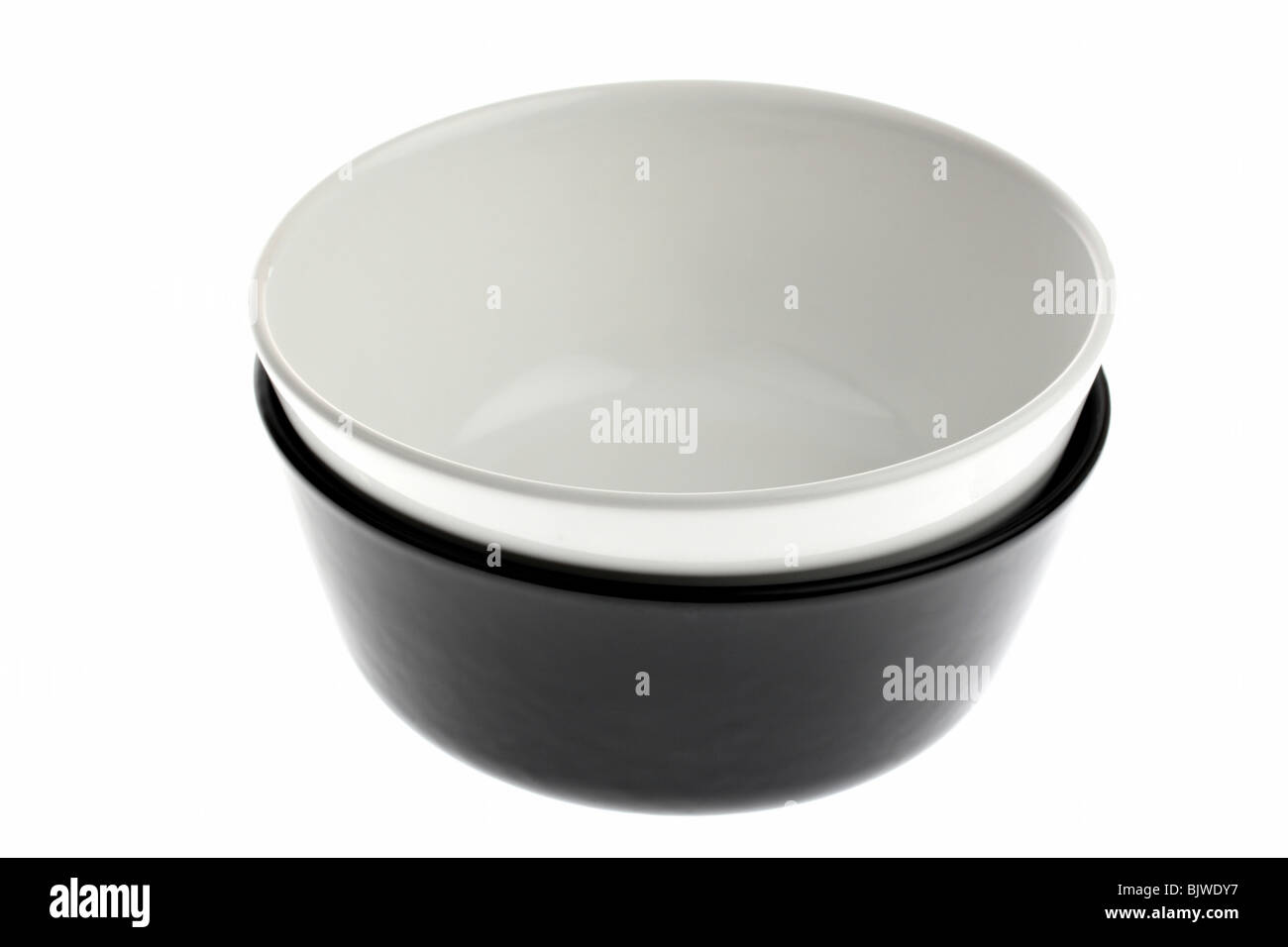 White ceramic bowl inserted in a black ceramic bowl isolated on pure ...