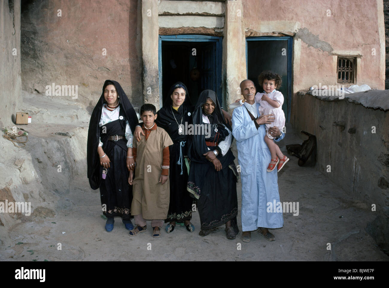 Berber family pose outside house in Tirmtmat village in the Anti Atlas ...