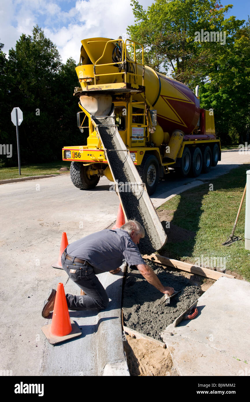 Cement workers work to repair roadway Stock Photo - Alamy