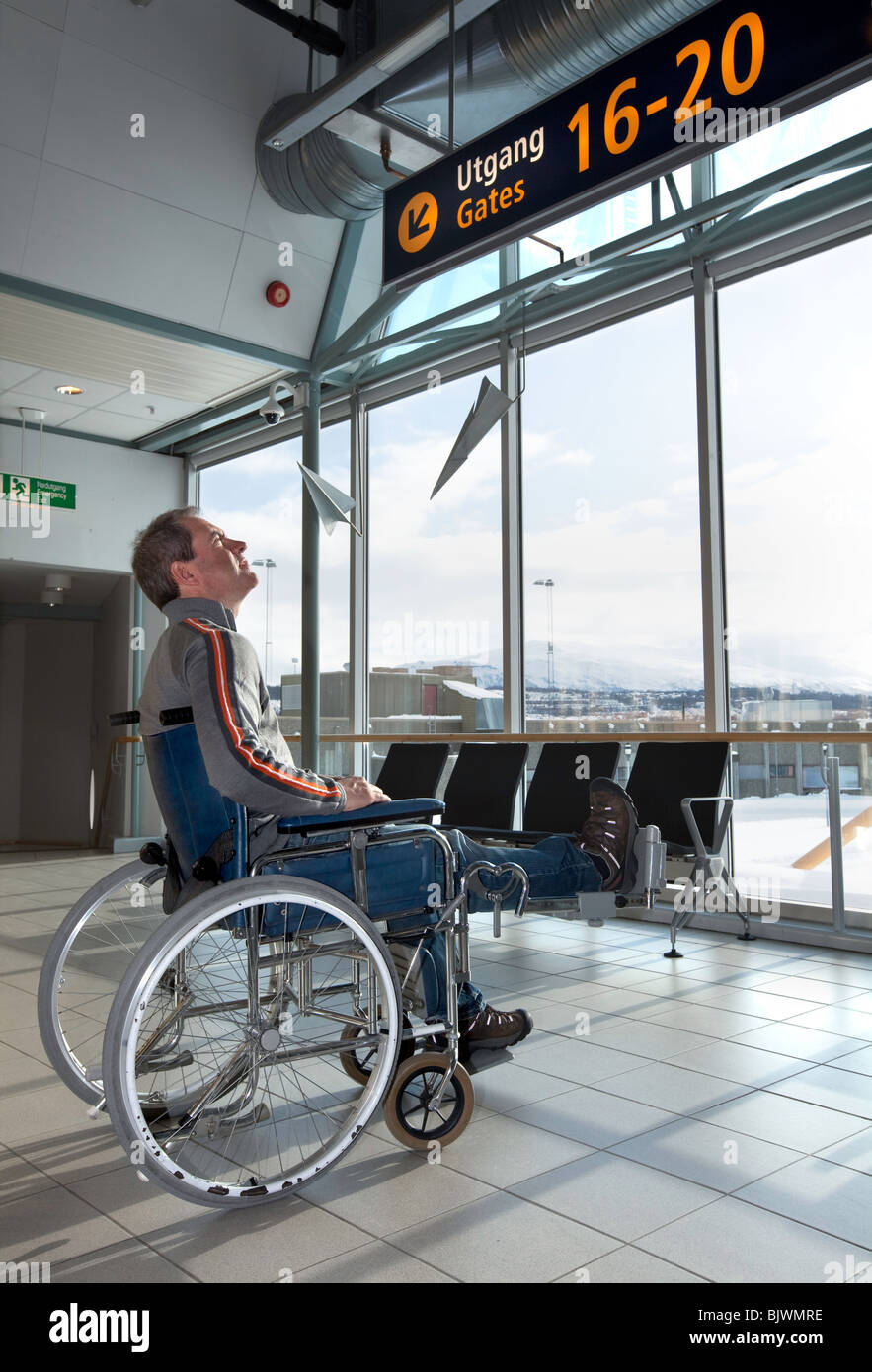 Disabled traveller in a wheelchair at airport Stock Photo - Alamy