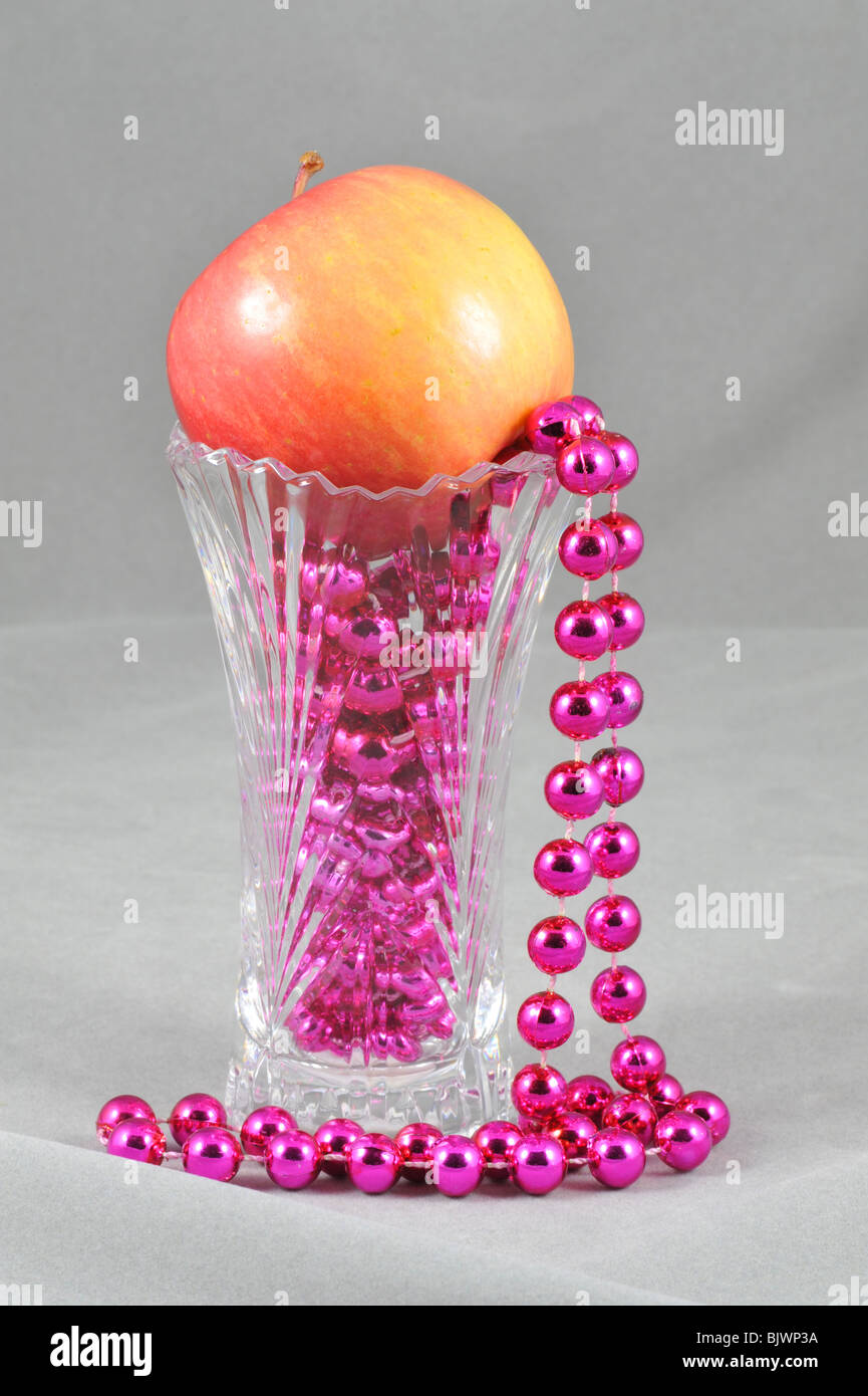 Beads, crystal vase and apple, still life, table top composition Stock ...