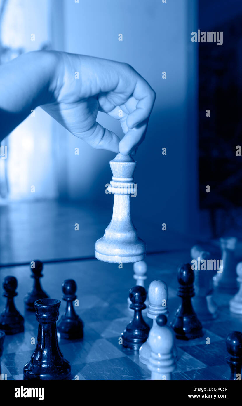 Chessmen on a table during game time Stock Photo - Alamy